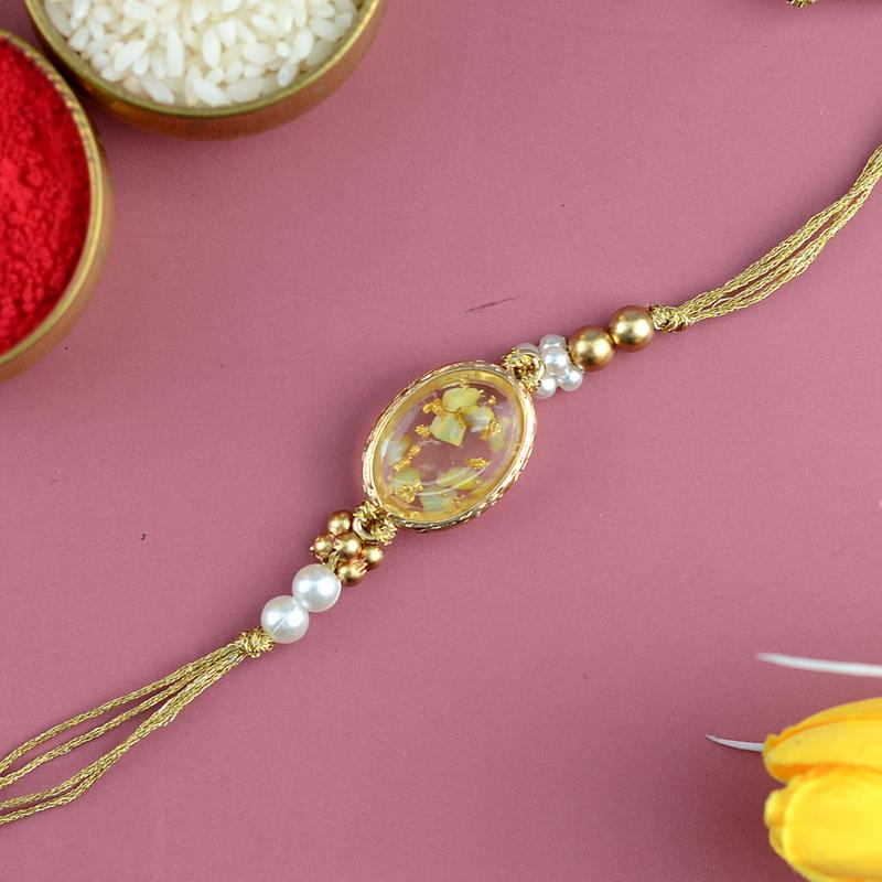 Clear Oval Resin Gold Rakhi DC26 | Designer Rakhi
