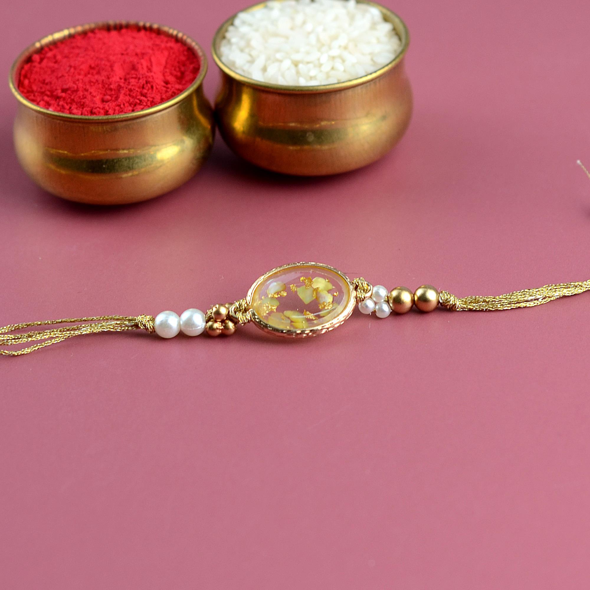 Clear Oval Resin Gold Rakhi DC26 | Designer Rakhi