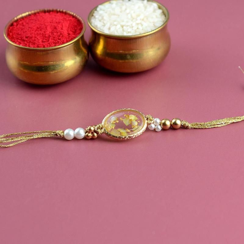 Clear Oval Resin Gold Rakhi DC26 | Designer Rakhi